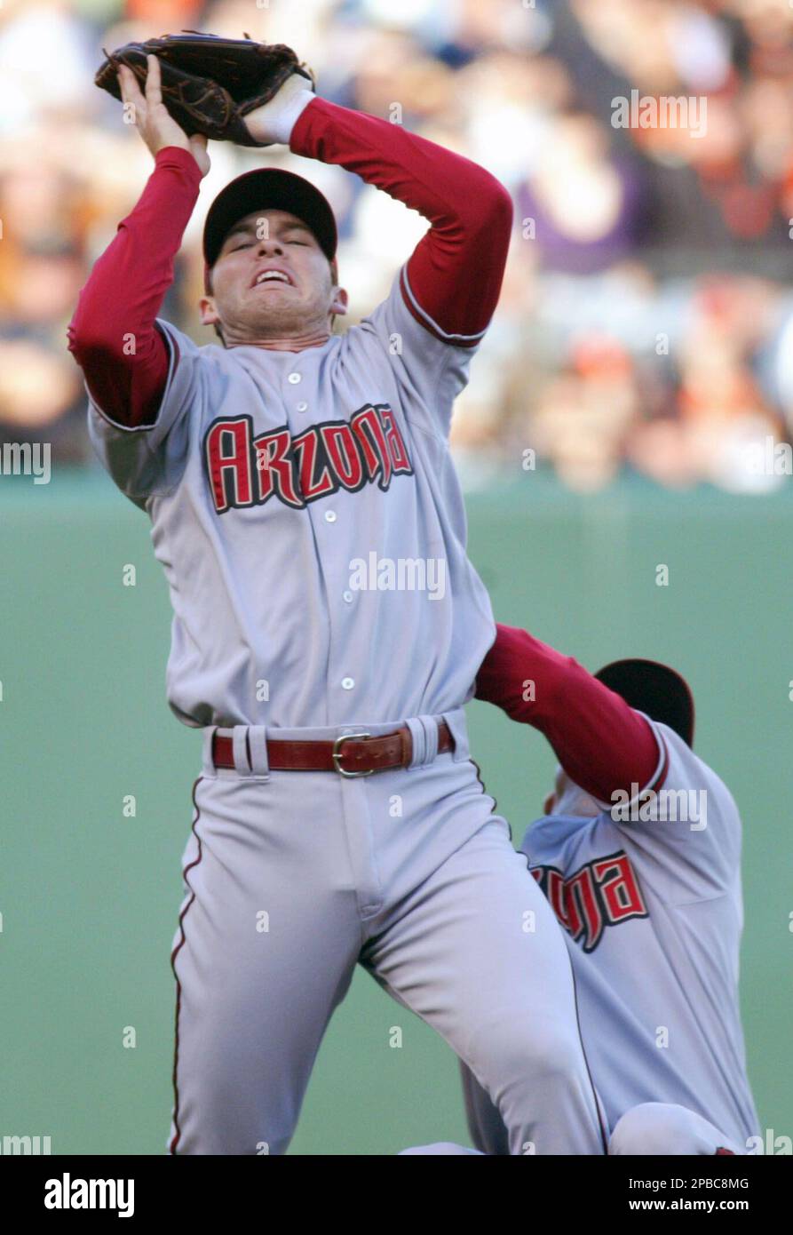 Arizona Diamondbacks Stephen Drew, front, catches a pop-up, as Scott ...