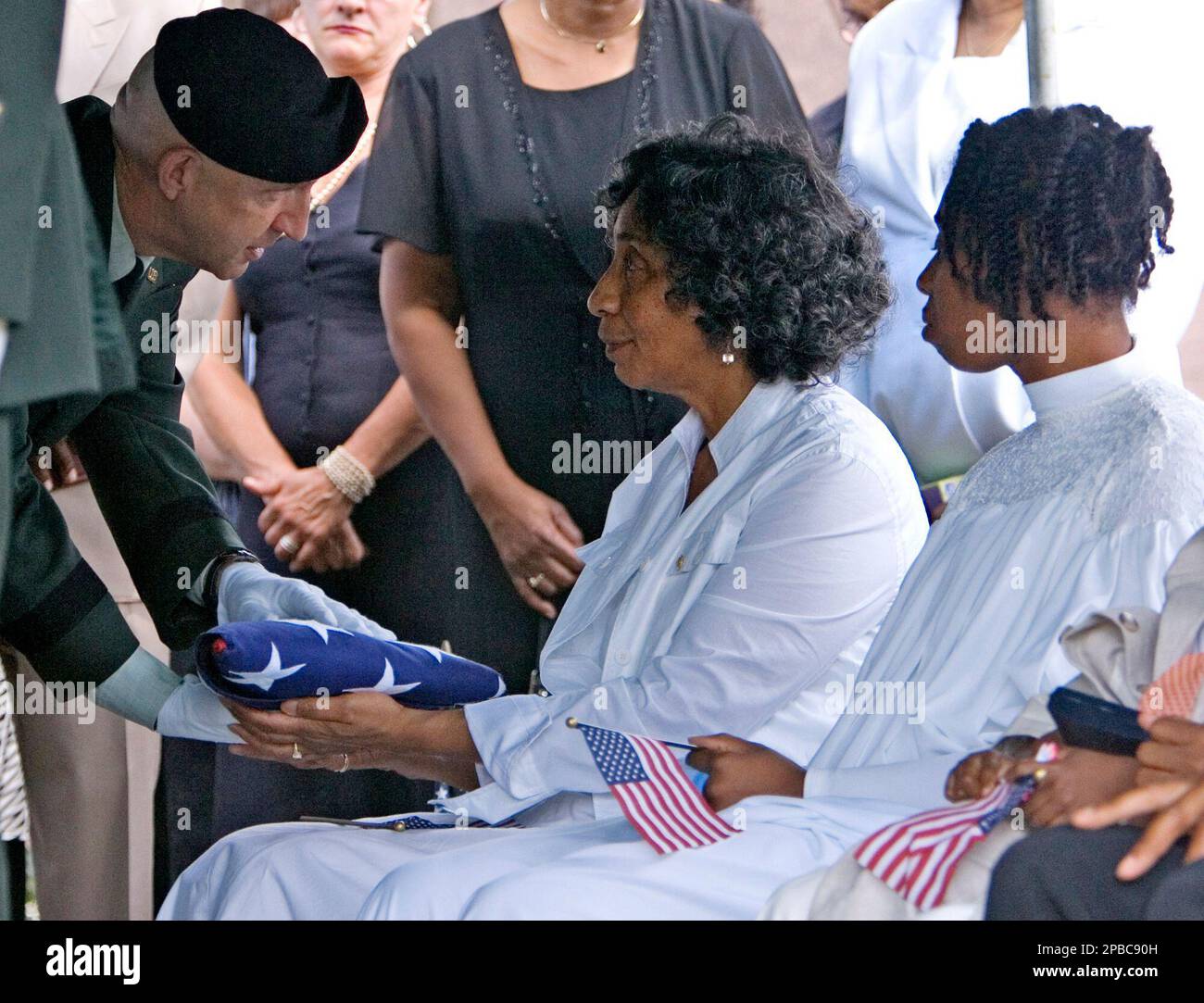 Army Sgt. Eric L. Snell's mother, Mittie White, accepts the flag that ...