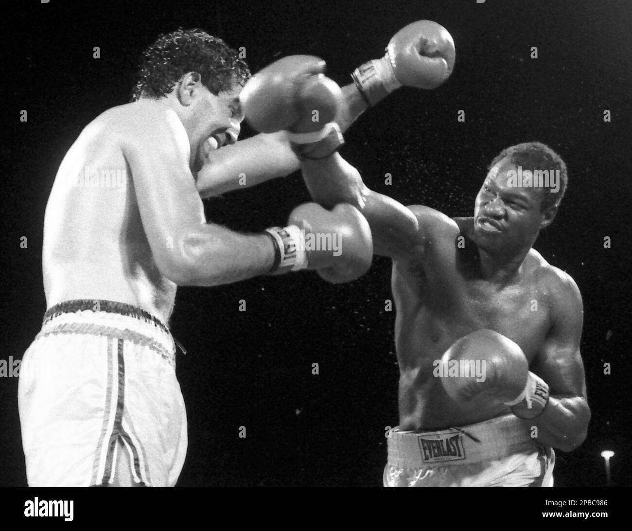 World Boxing Council champion Larry Holmes, right, delivers a flurry of ...
