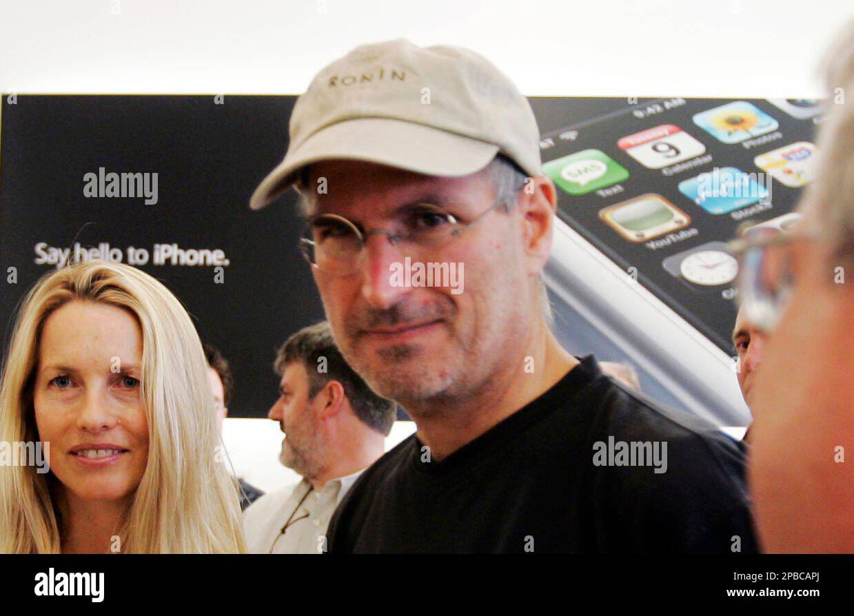 Apple CEO Steve Jobs, center, and his wife Laurene Powell meet with ...