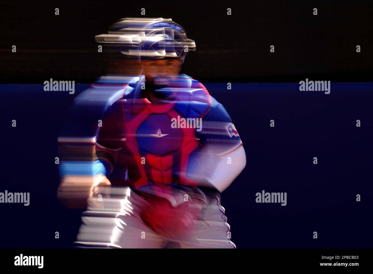 Texas Rangers catcher Sandy Leon warms up in the bullpen before of a ...