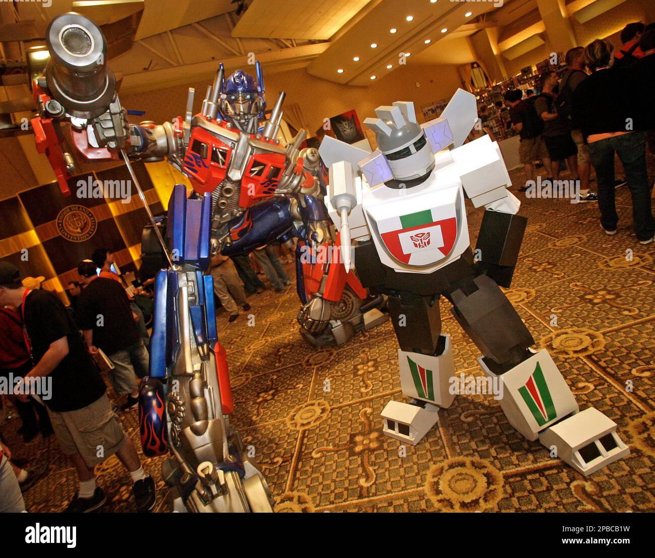 Rosemary Ward, right, from Philadelphia, dressed as a transformer, poses in front of a 10-foot ...