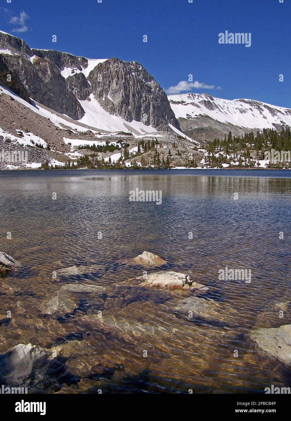 Lake Marie sits below the towering peaks of the Snowy Range, in this ...