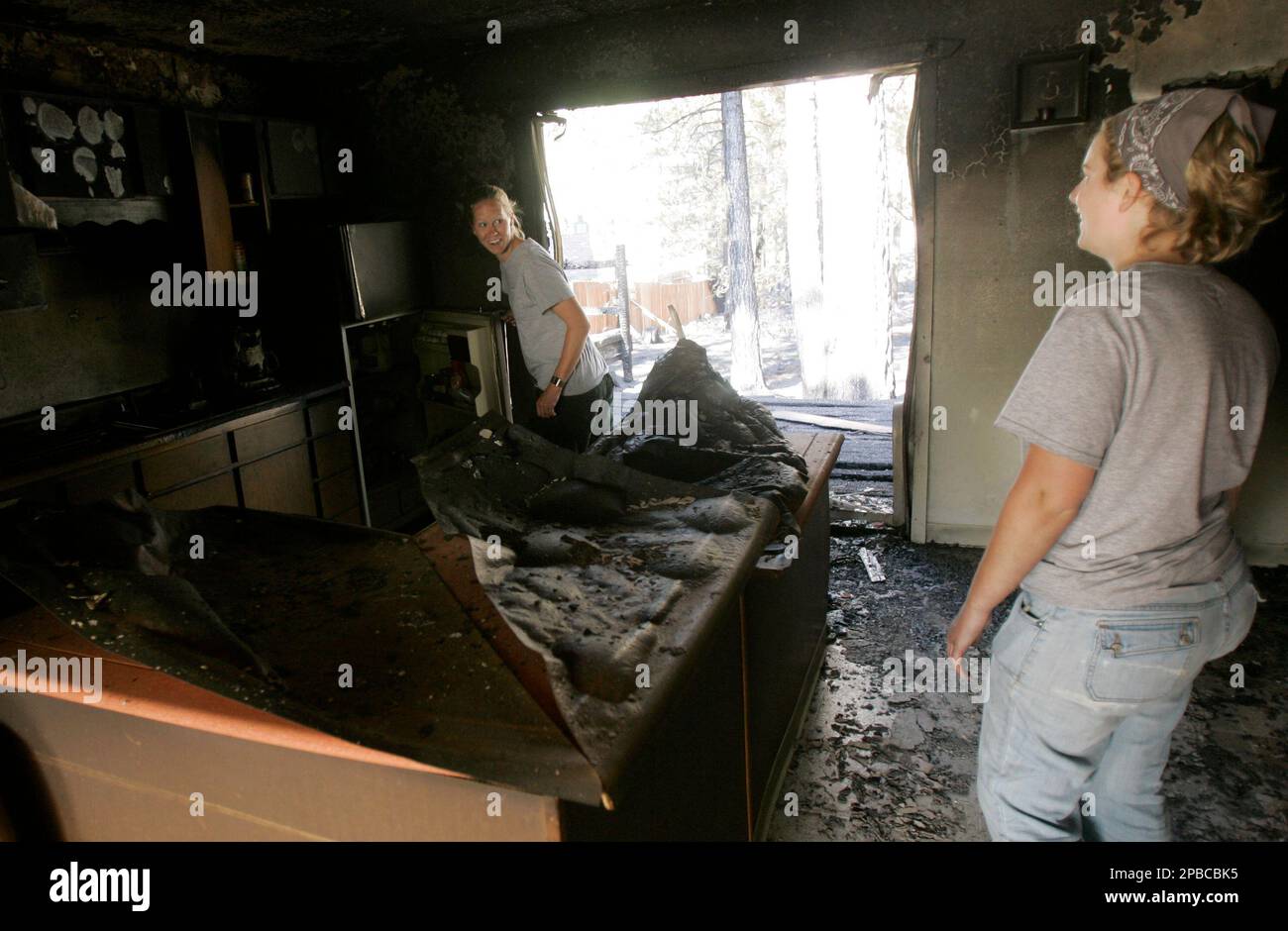 Stephanie Bant, left, laughs with roommate Heather Gann as she looks ...