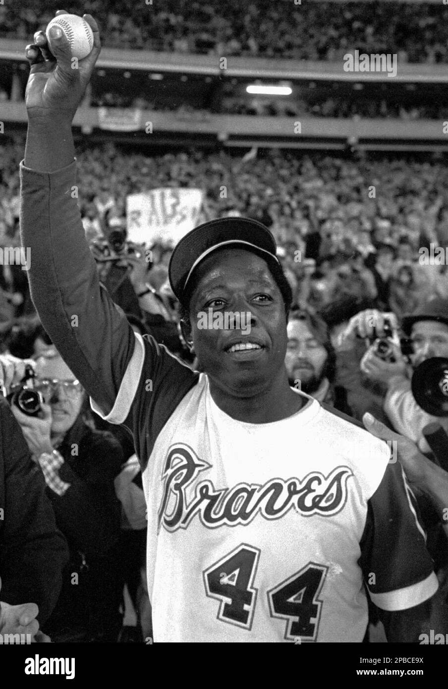 Atlanta Braves slugger Hank Aaron holds aloft the ball he hit for his ...