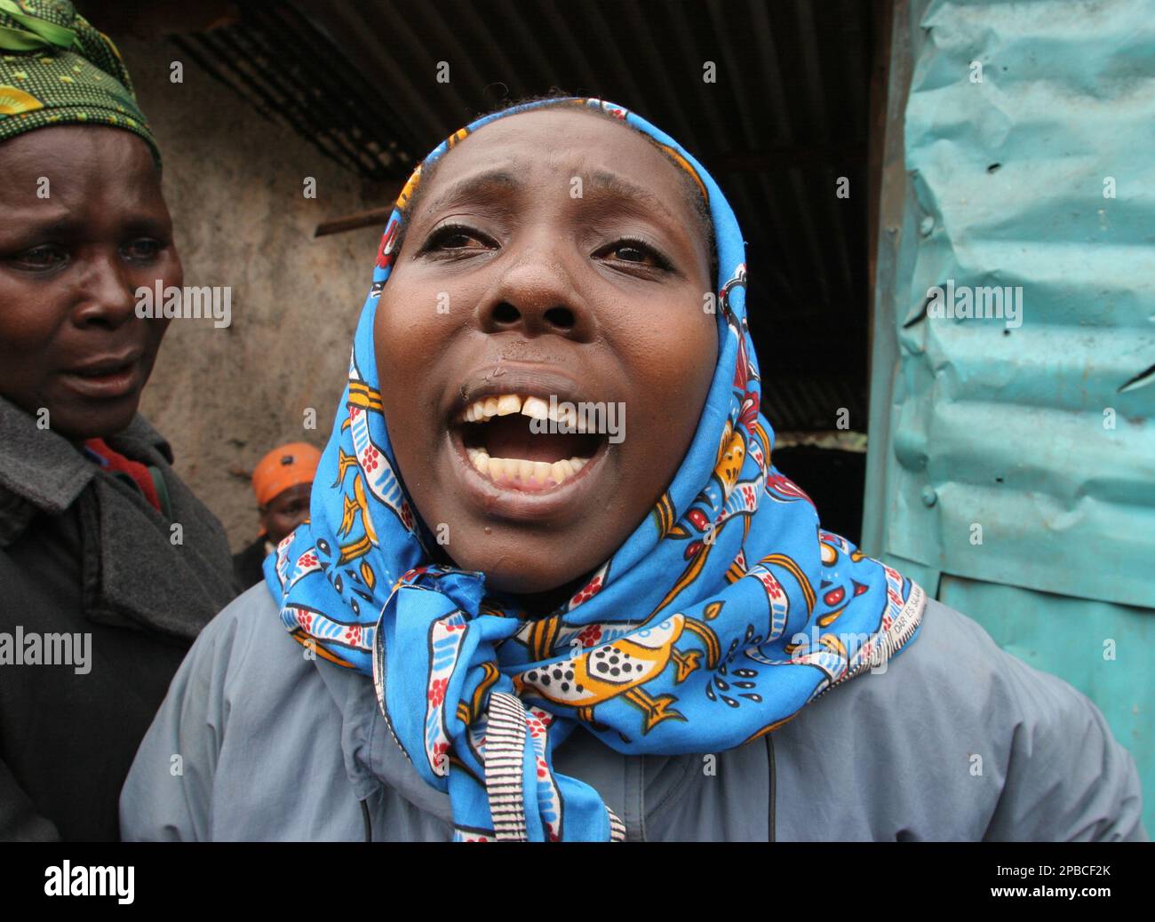 A relative cries after four people were killed overnight by an armed ...