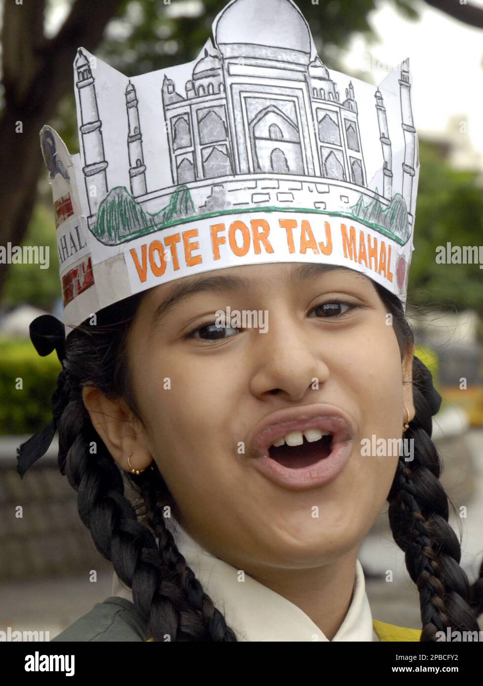 A school girl shouts support slogans for the Taj Mahal to garner votes ...