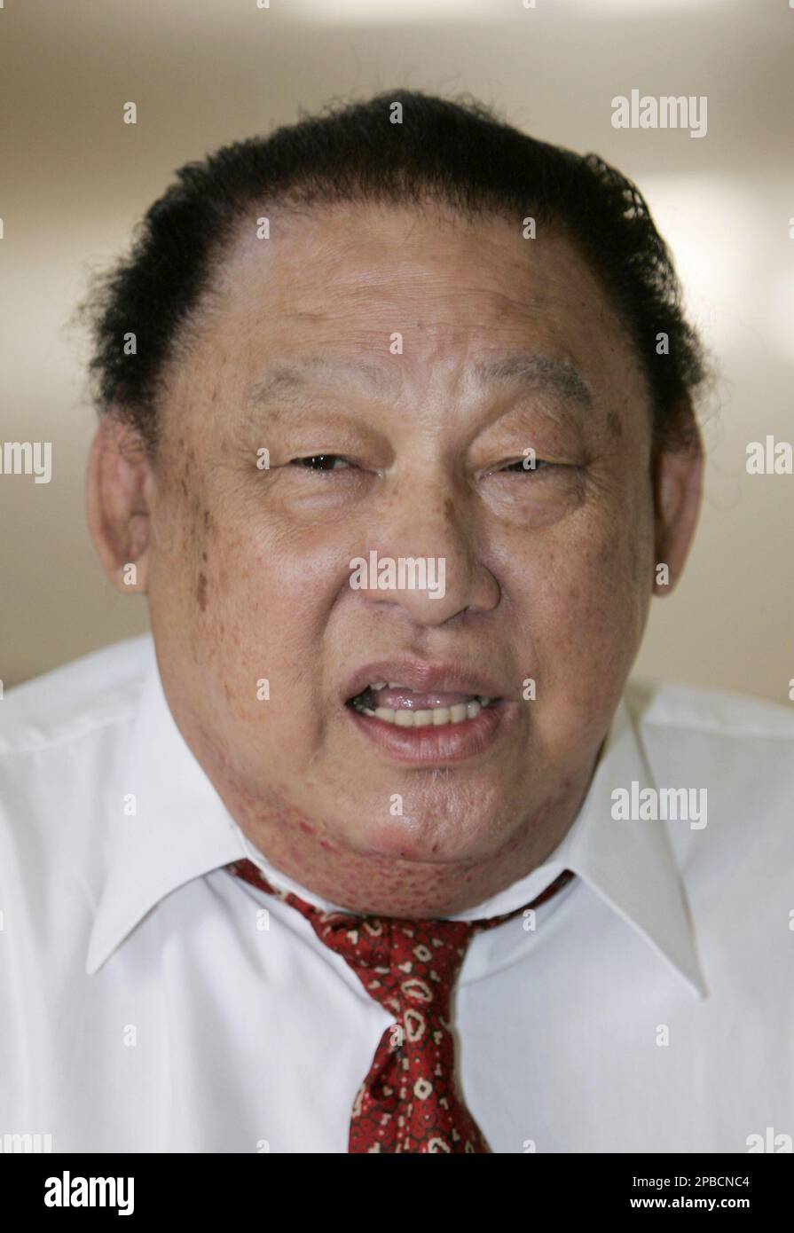 Former steel tycoon Eric Chia smiles as he arrives at a courtroom in ...