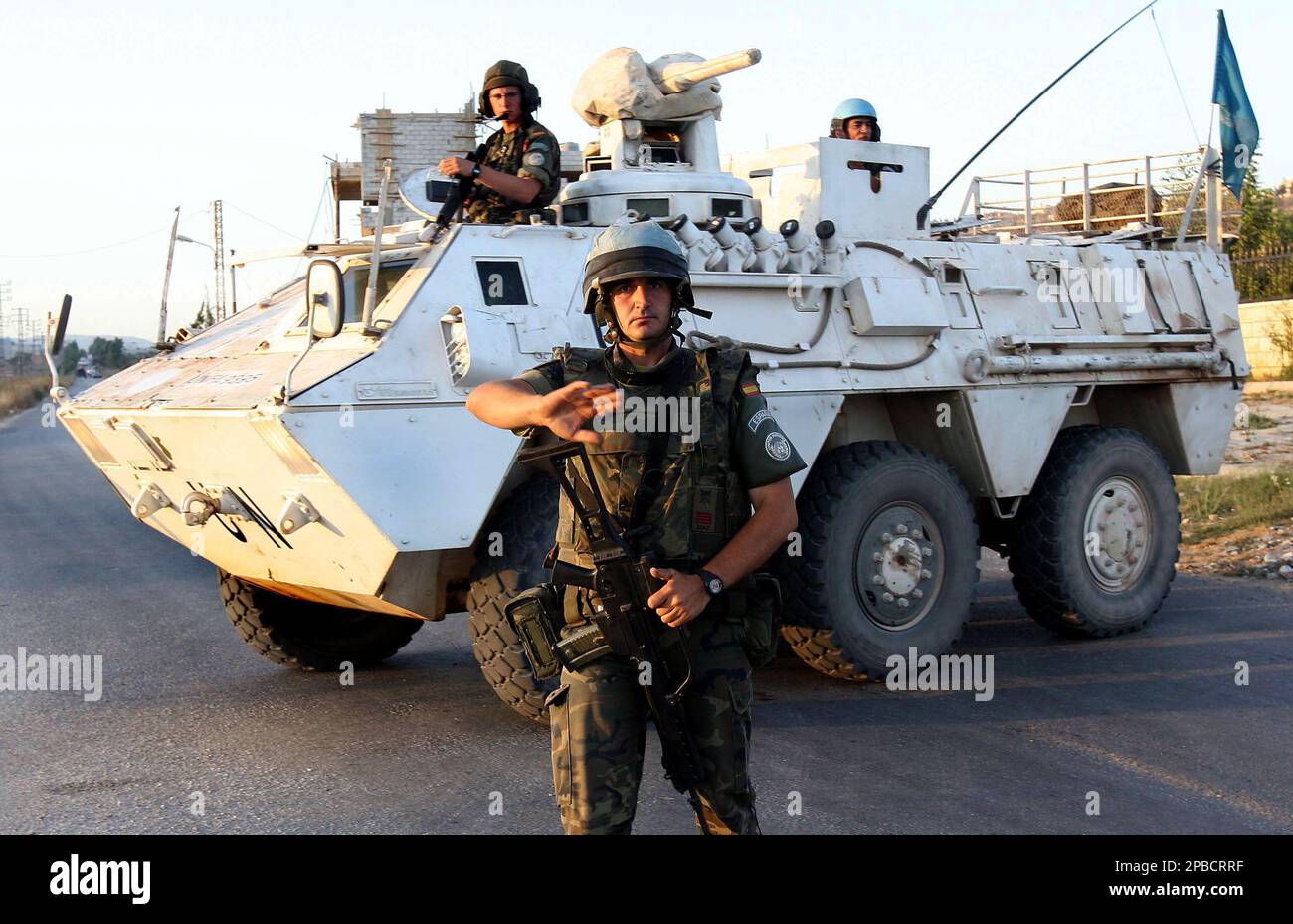 A Spanish U.N peacekeeper, gestures as he stands in front of his ...