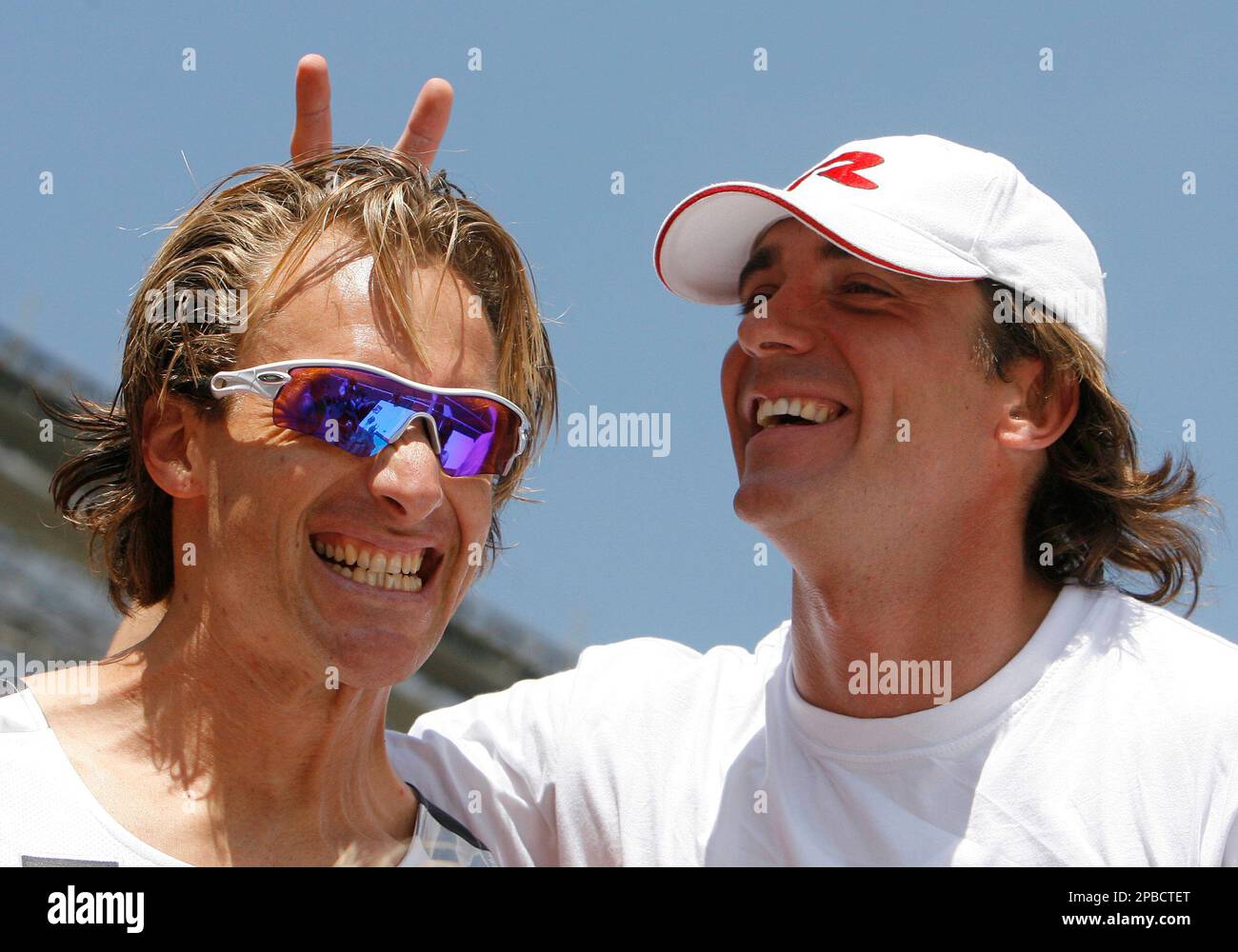 Germany's Tim Lobinger, left, and Poland's Adam Kolasa, right, joke ...
