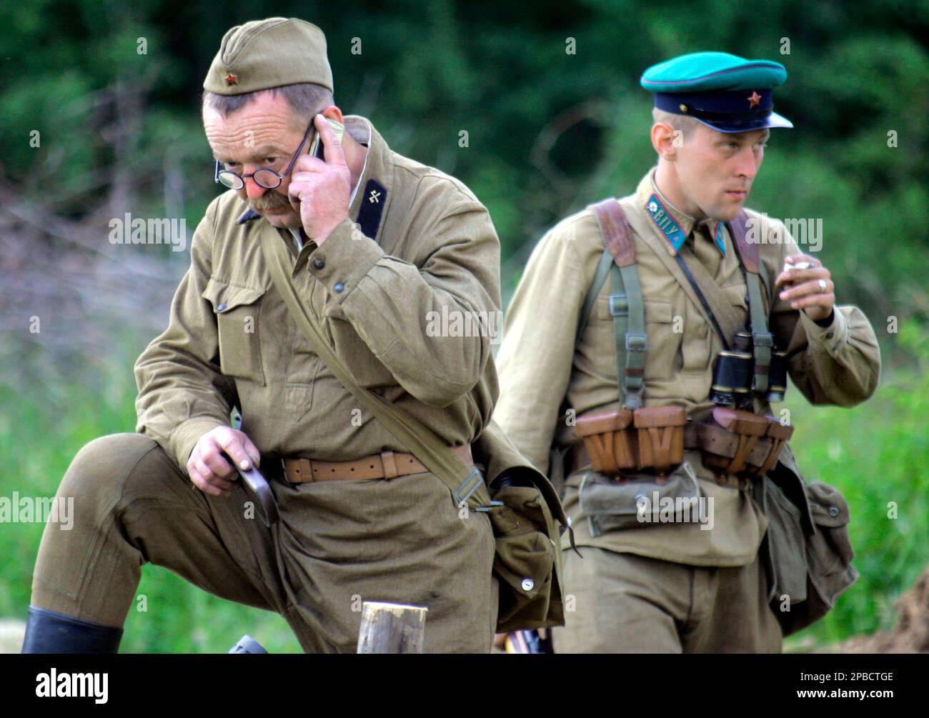 World War II re-enactors dressed as a Soviet border guard, right, and a ...