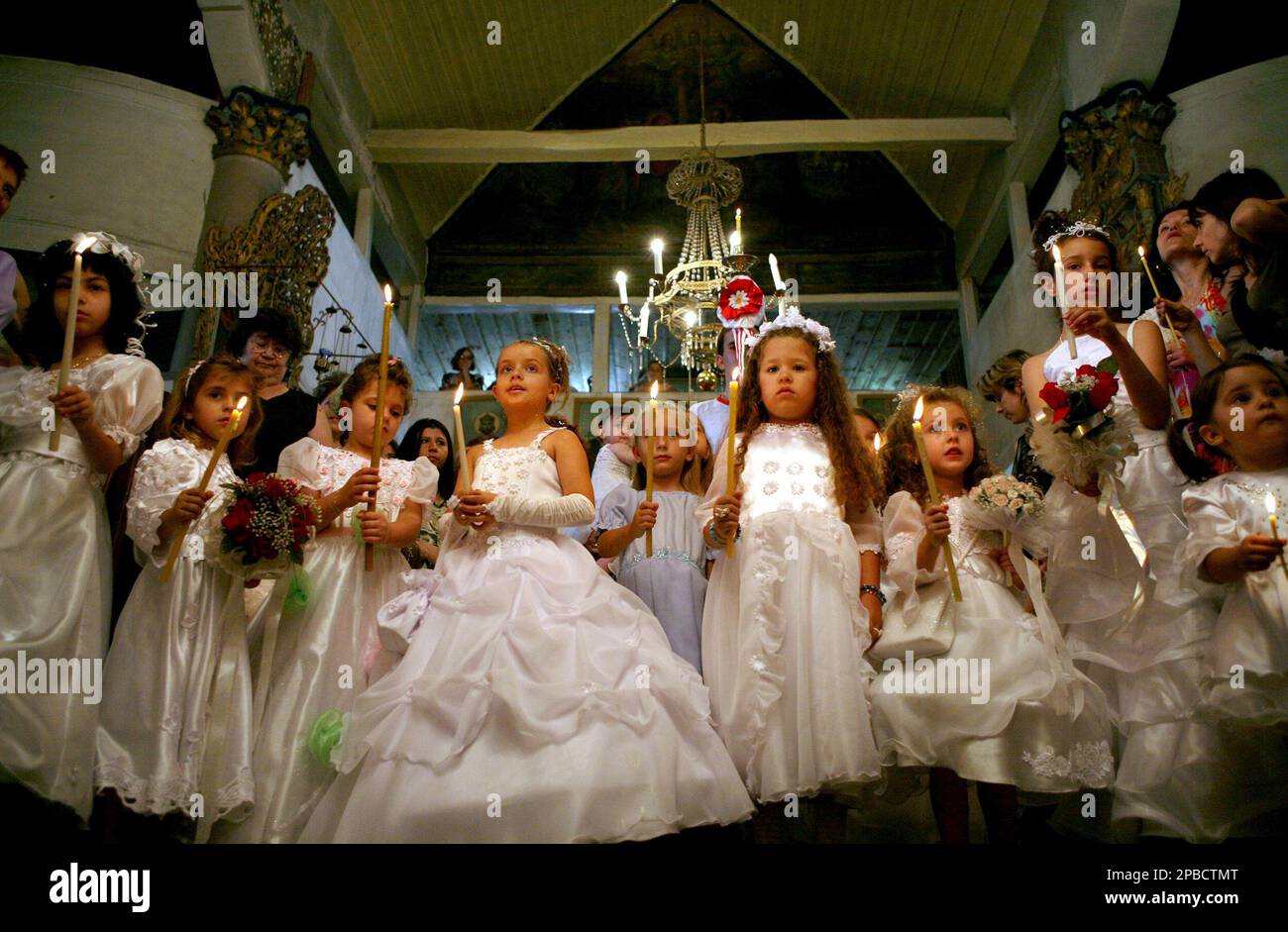 Girls dressed in wedding dresses attend the celebrations of the ...