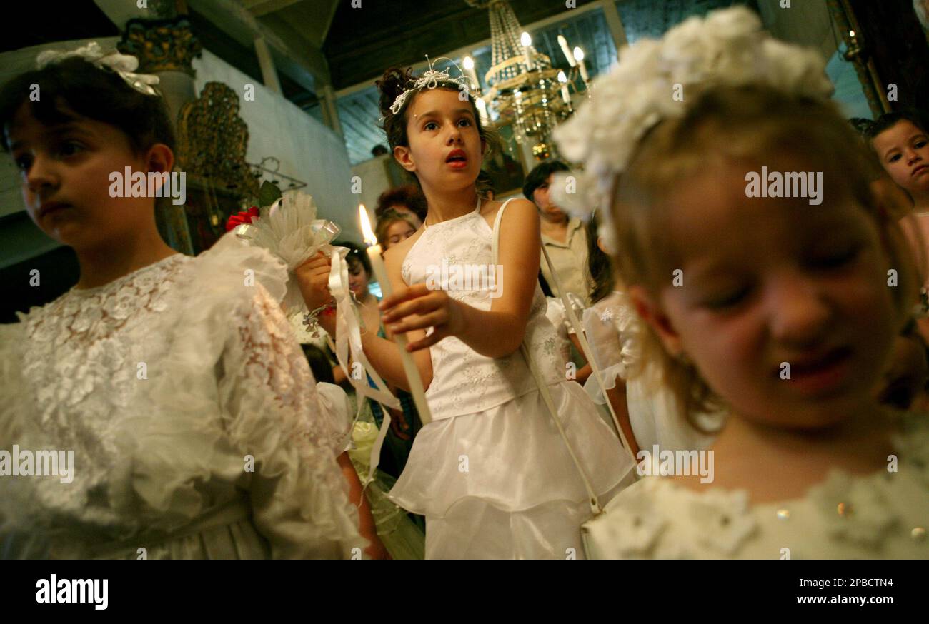 Girls dressed in wedding dresses attend the celebrations of the ...