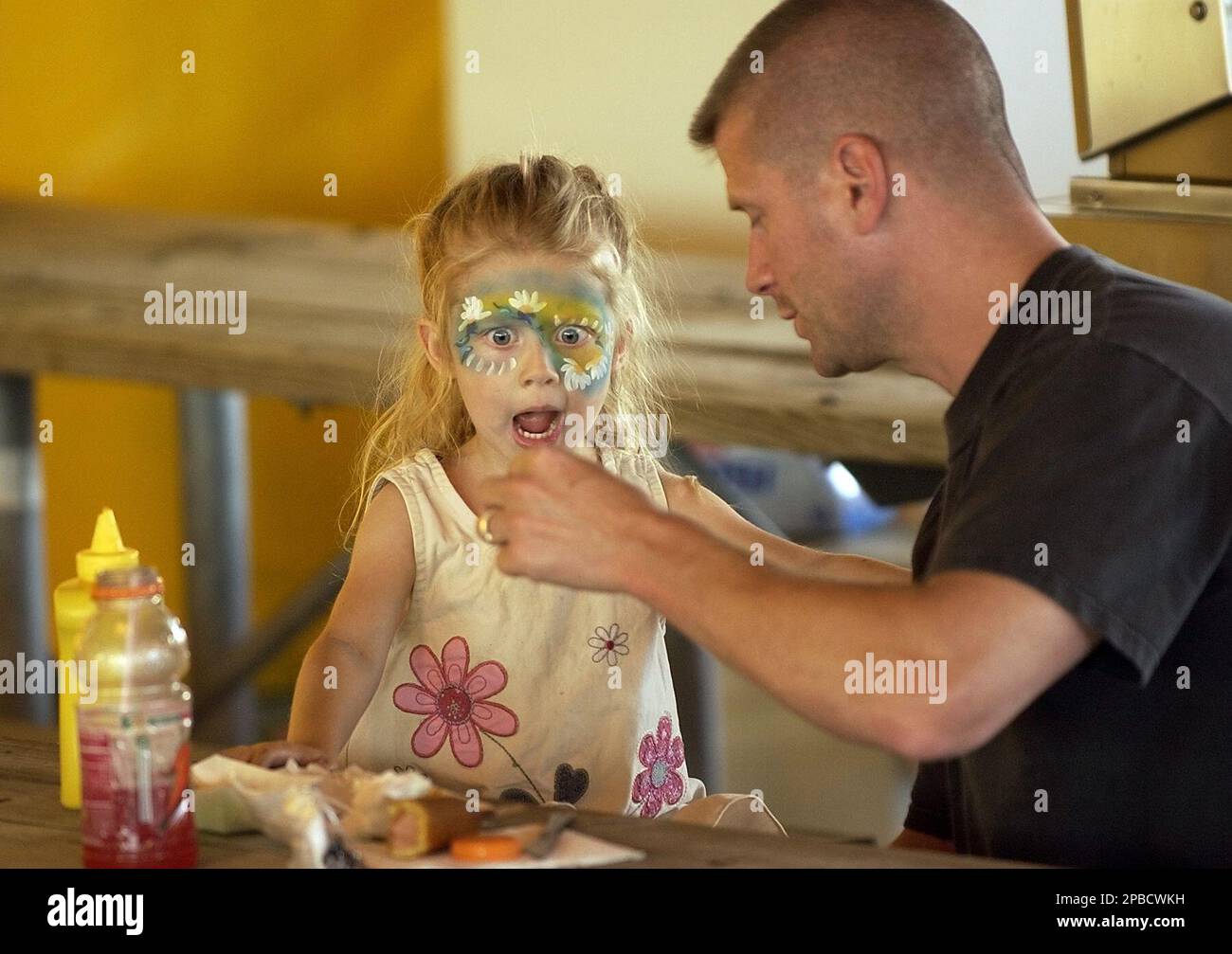 Lilly Stanglewicz,3, of Bourbonnais, opens wide for a french fry fed to ...