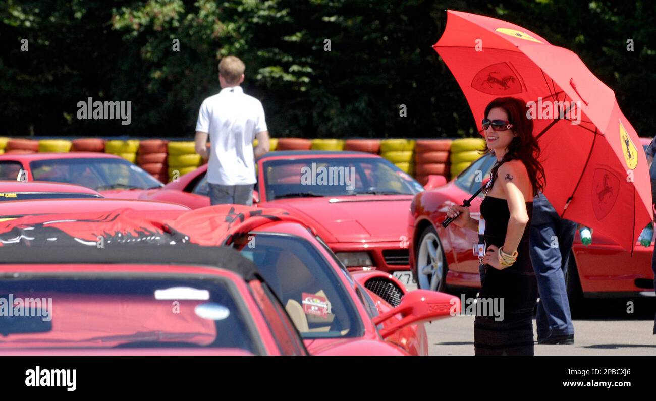 A Ferrari's fan is all smiles near Ferrari cars at the luxury and ...