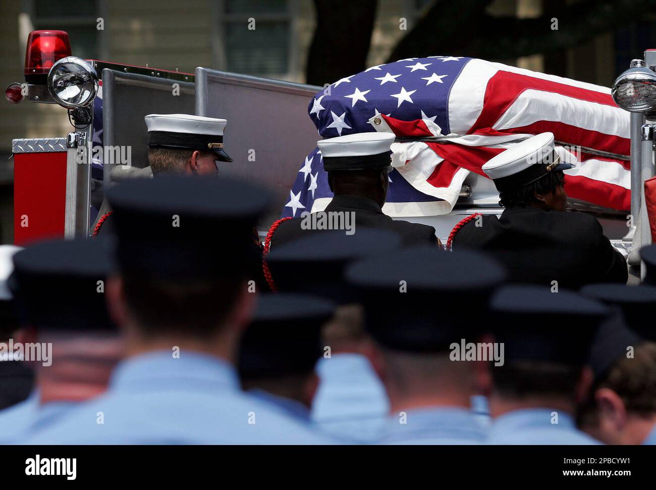 Charleston Firefighters place the casket of Capt. Billy Hutchinson atop ...