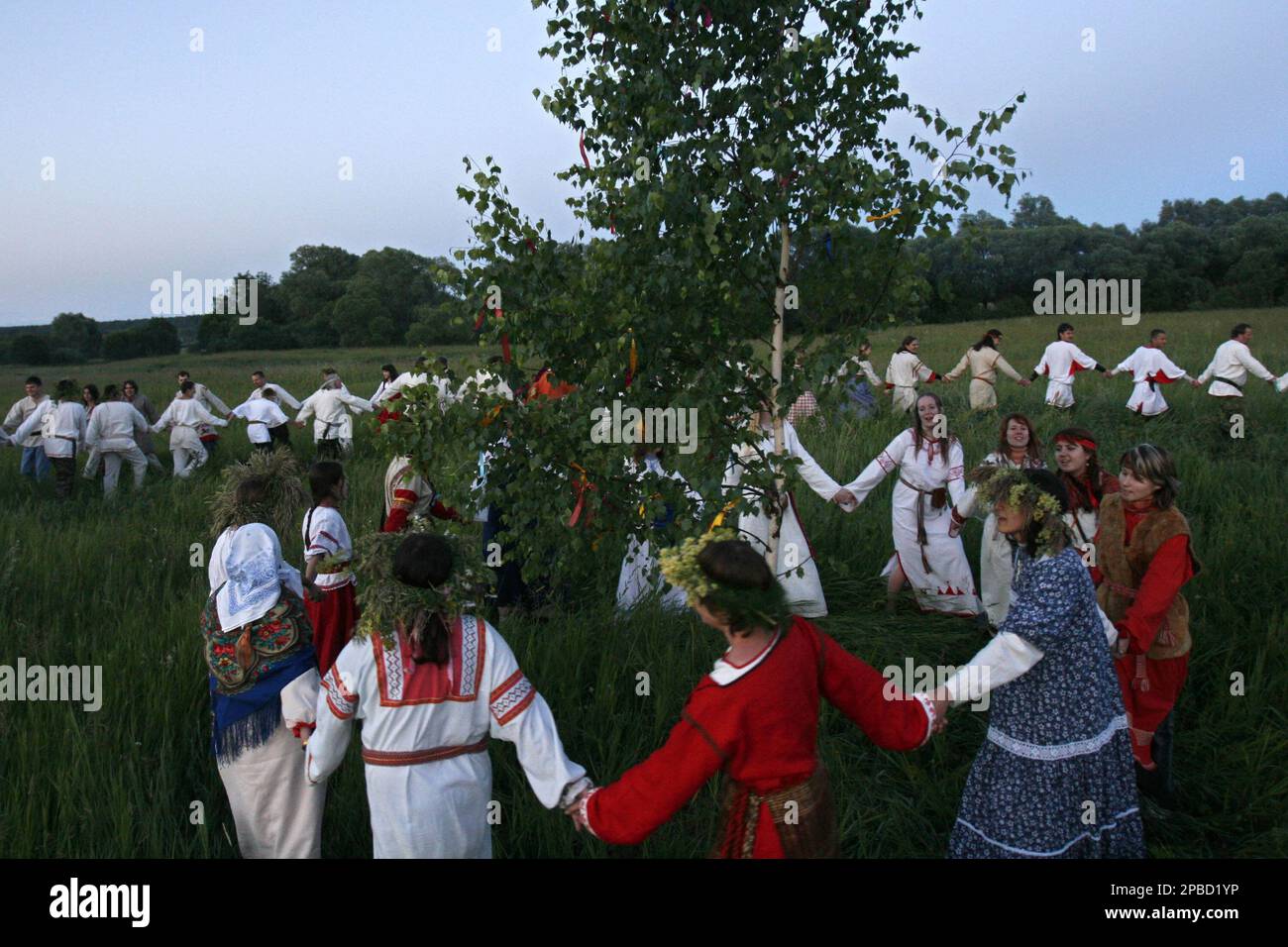 Russian neo-pagans form a circle around a birch tree celebrating the ...