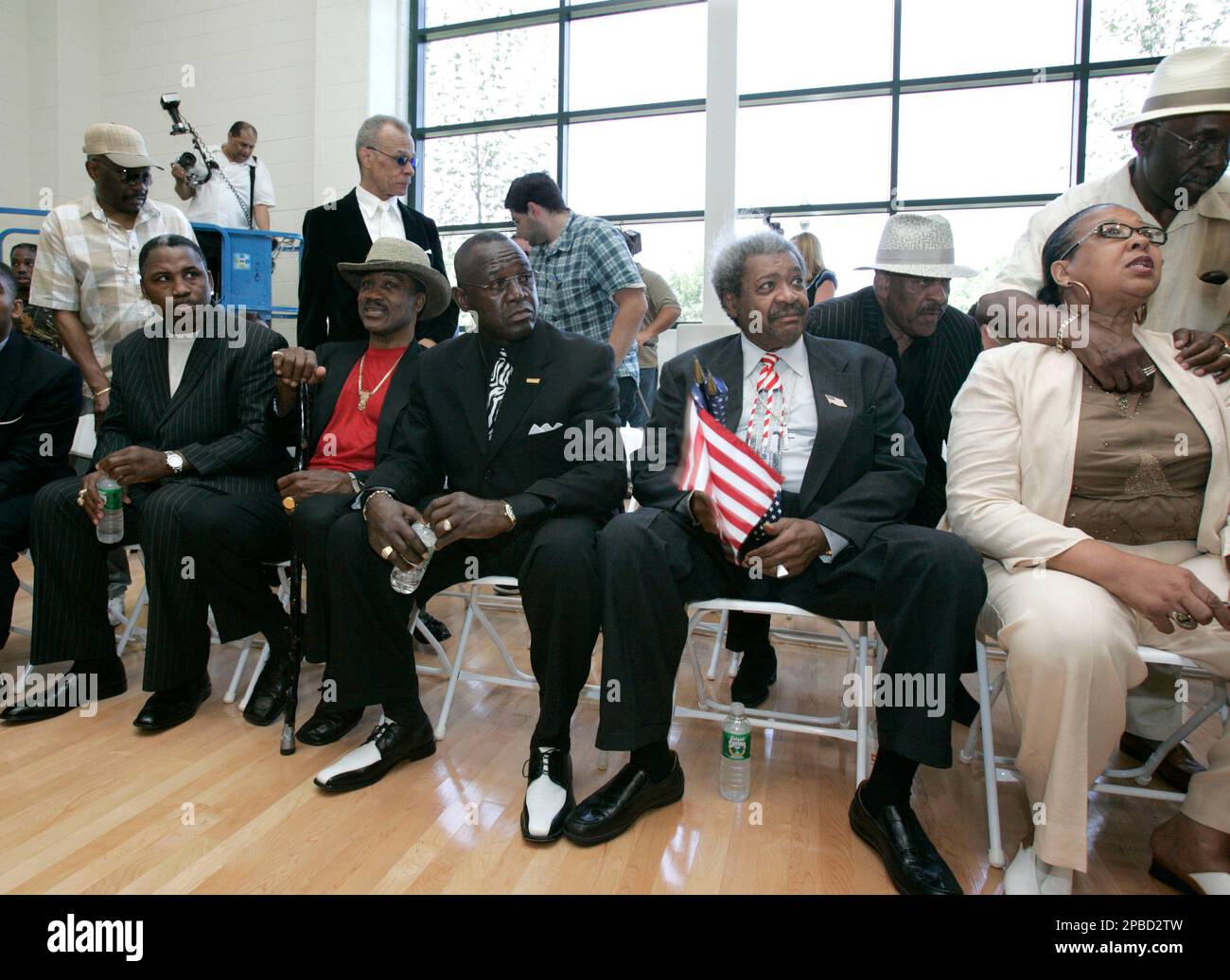 Boxing promoter Don King, seated second from right, sits with, seated ...