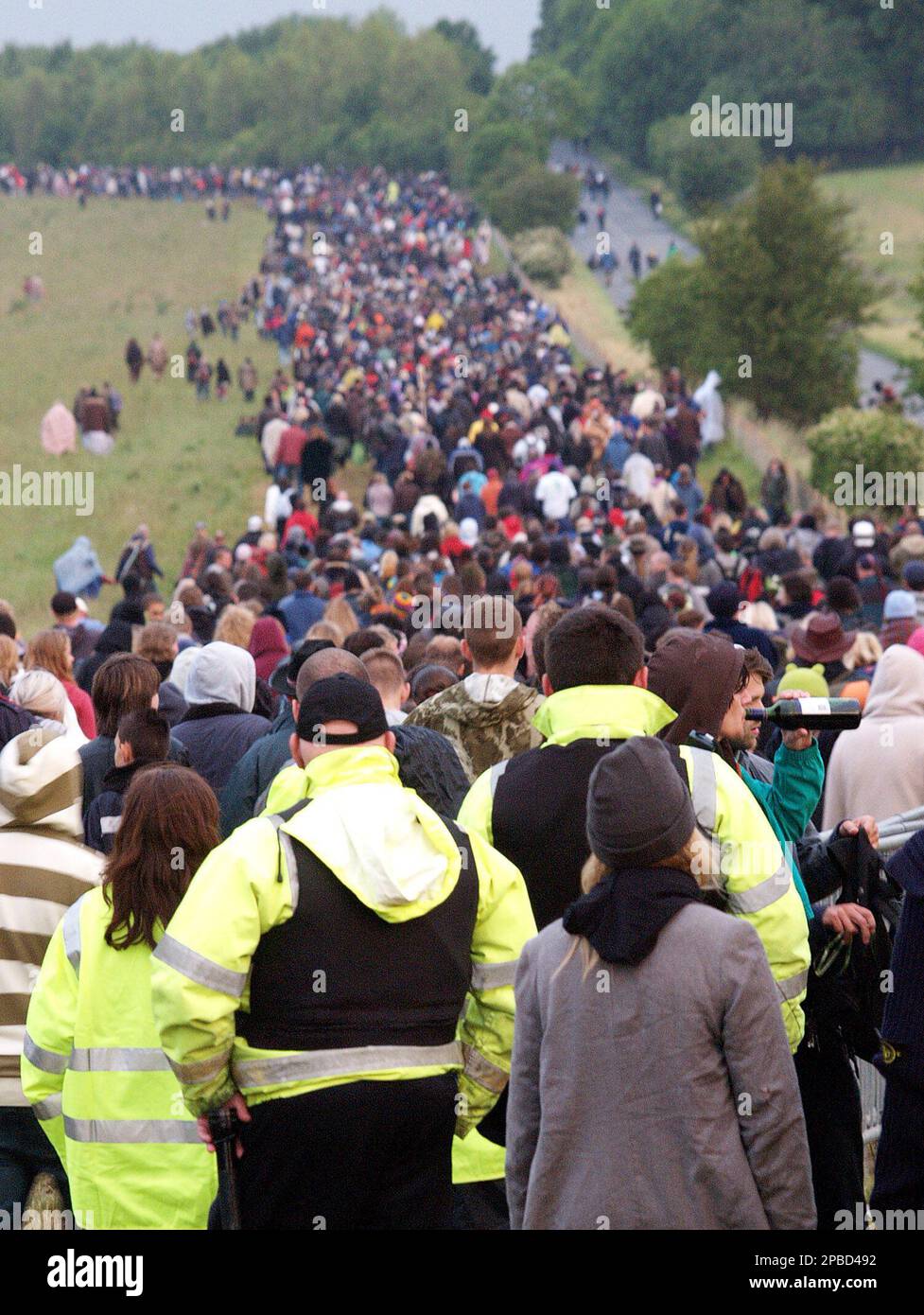 Security personnel watch some of the many thousands who came to the ...