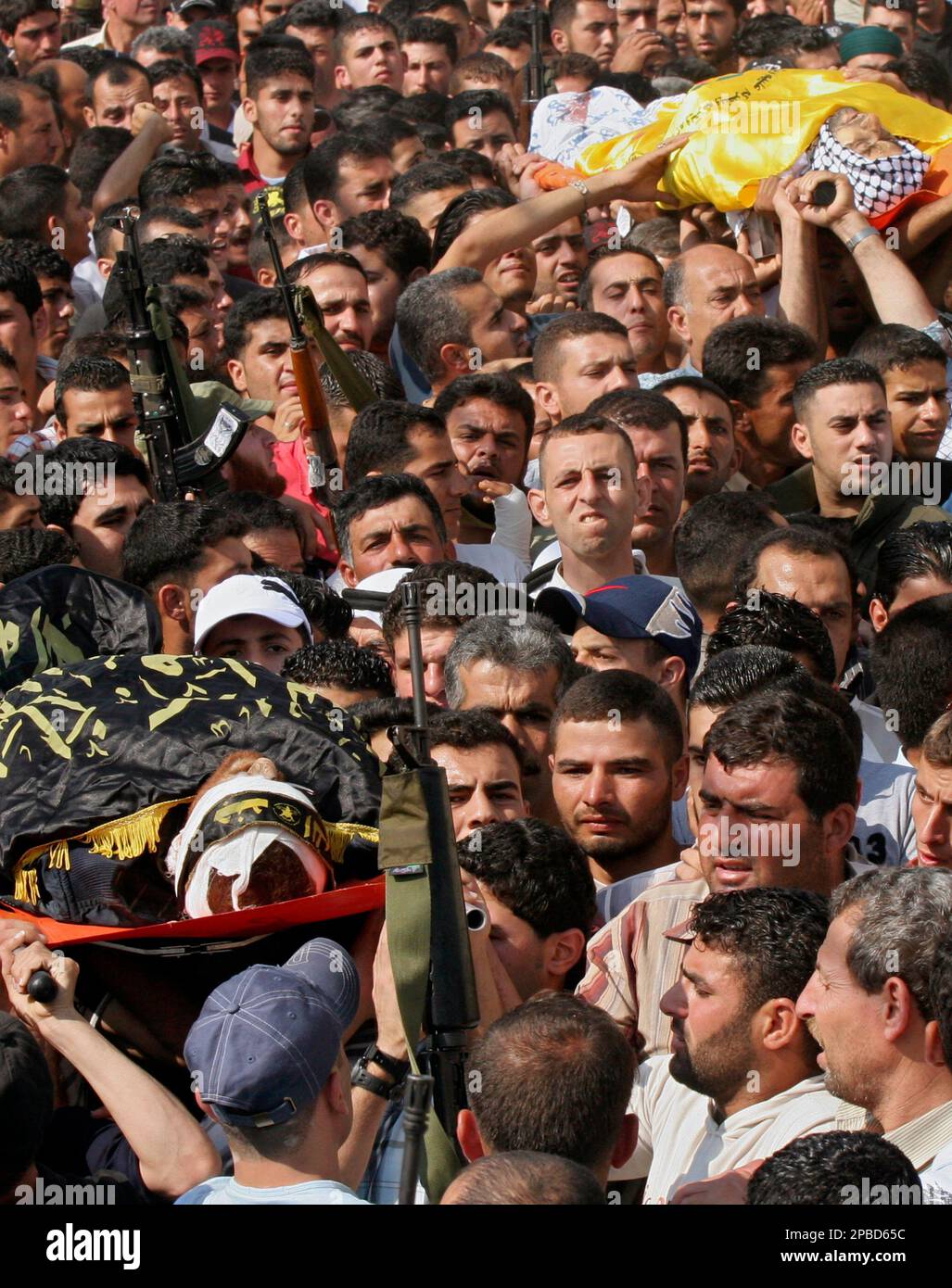 Palestinian mourners carry the bodies of Zeyad Malaysheh, left, 32, the ...