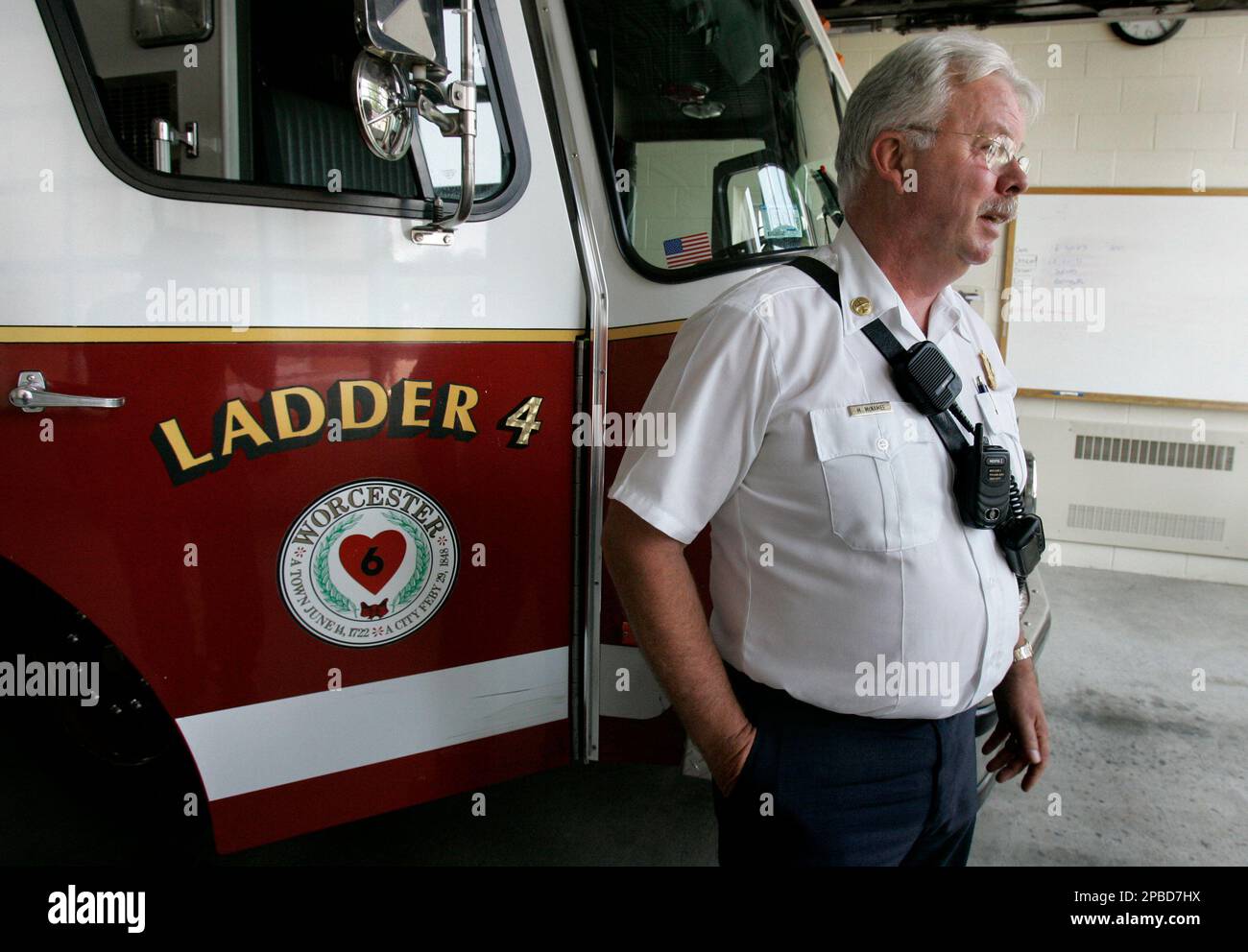 Worcester Fire Department District Chief Mike McNamee leans on a ladder ...