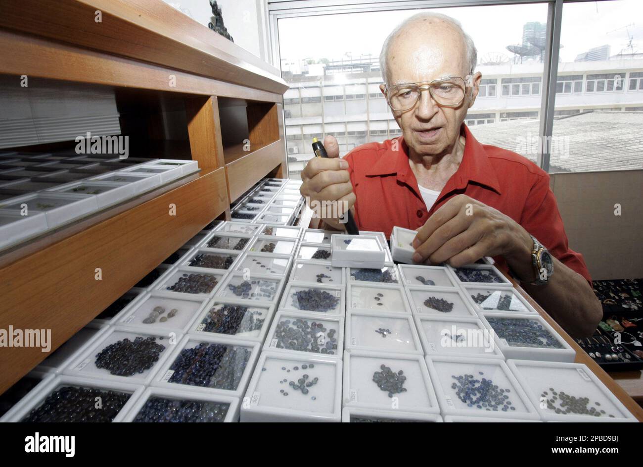 David Glickman poses next to trays of polished gems at his office in ...