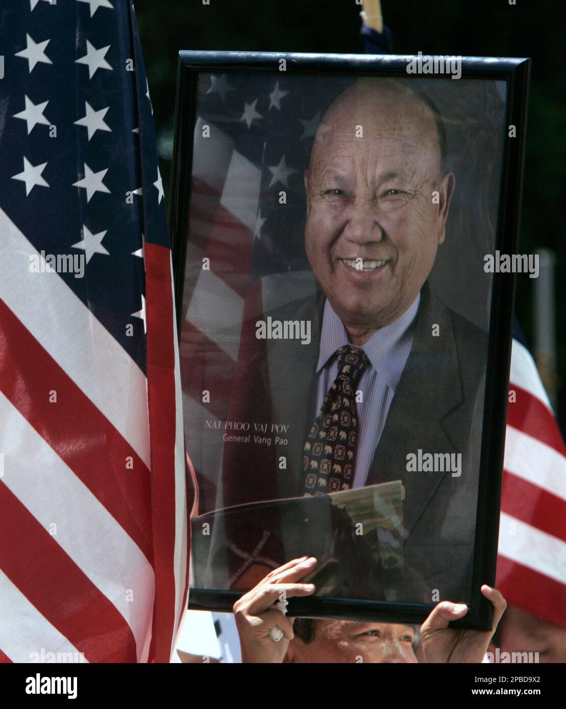 Sia Khang, of Tulare, holds up a photograph of Laotian General Vang Pao ...