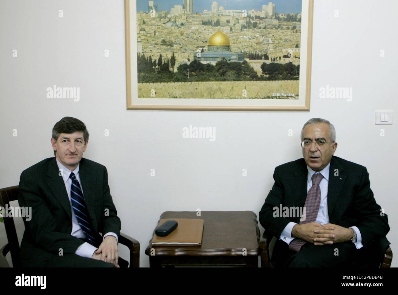Newly-appointed Palestinian Prime Minister Salam Fayyad, right, sits ...