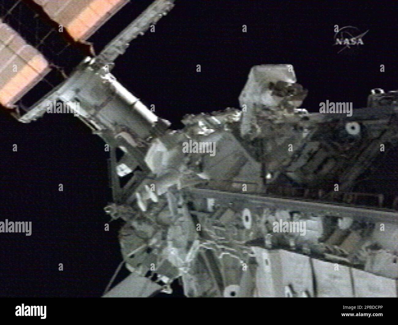 In this image from NASA TV mission specialists Steve Swanson and Pat ...