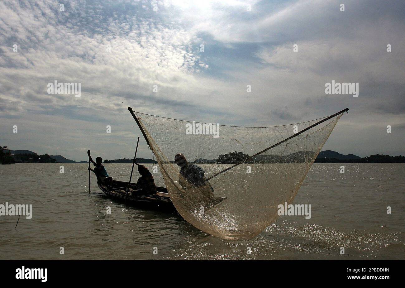Fishermen use a country boat to fish in River Brahmaputra as monsoon ...