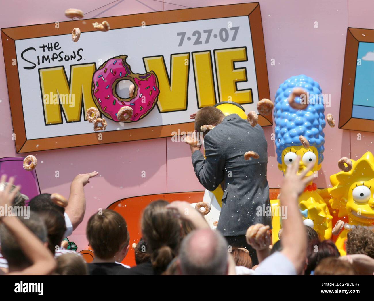 A crowd hurls donuts at actor Cody Mobley as he portrays a FOX network ...
