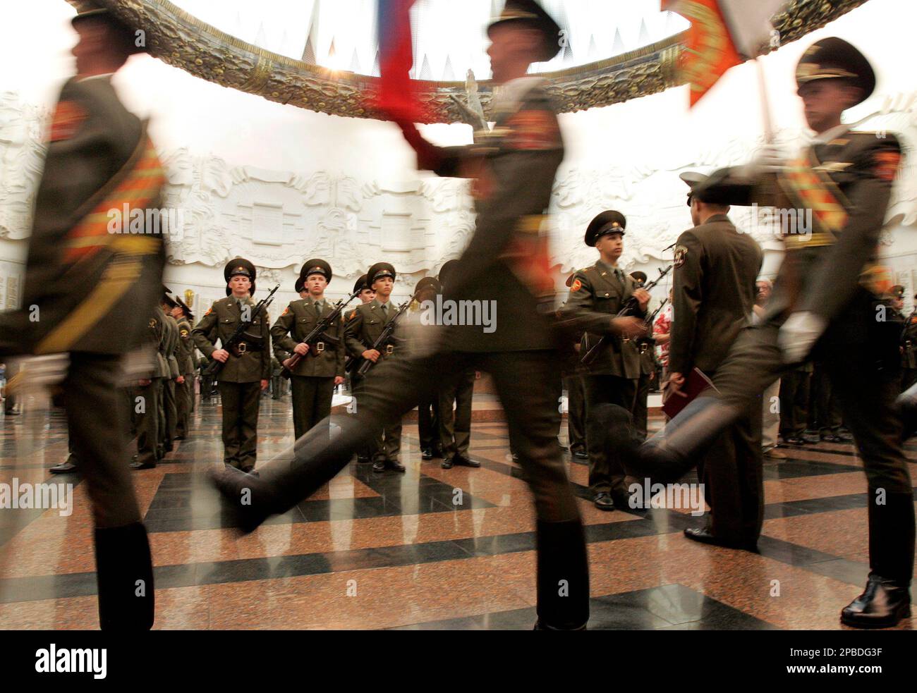Honor guard soldiers carry flags in front of Russian conscripts ...