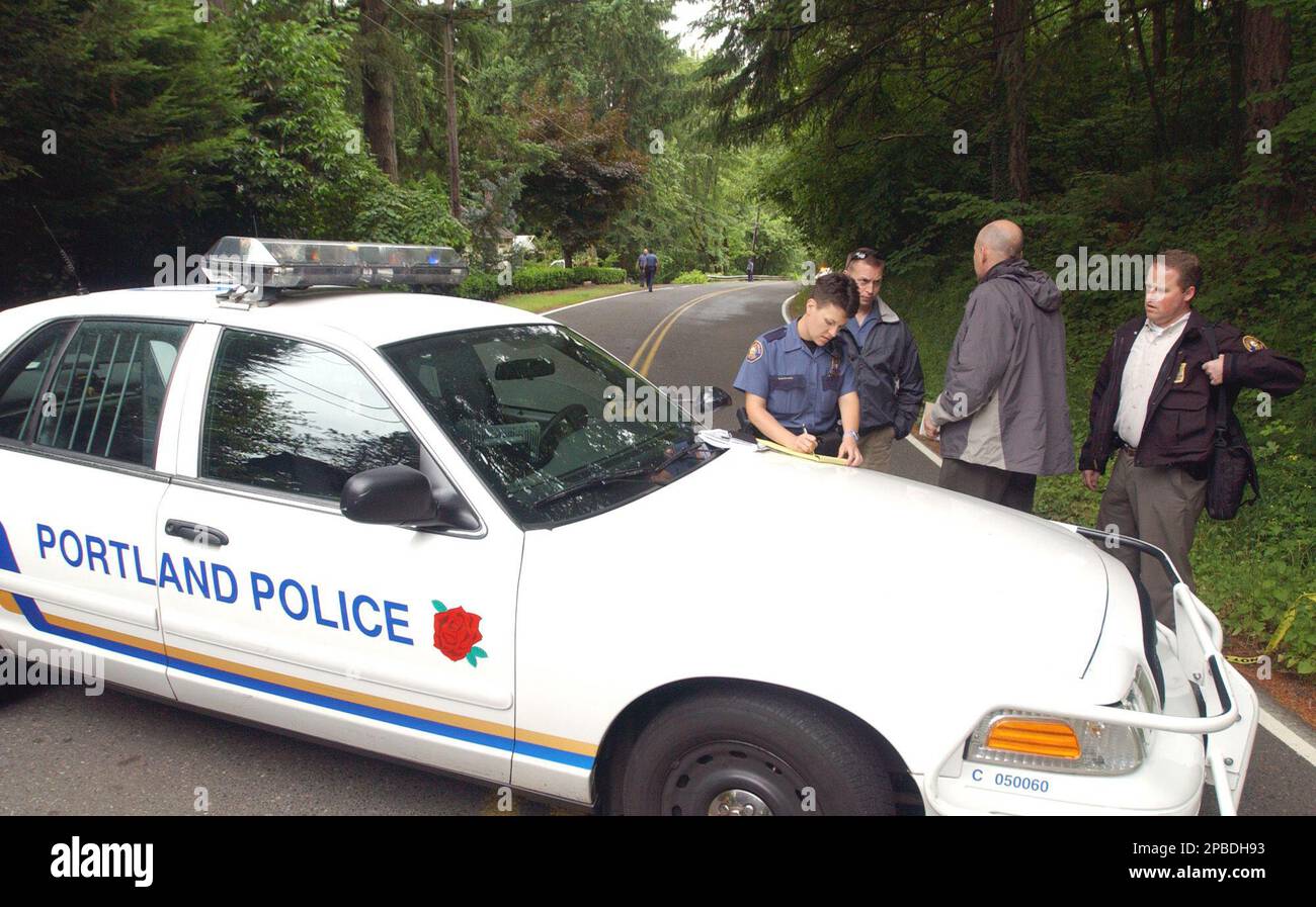 Portland Police officer Christina Hansen-Tuma, center, checks in ...