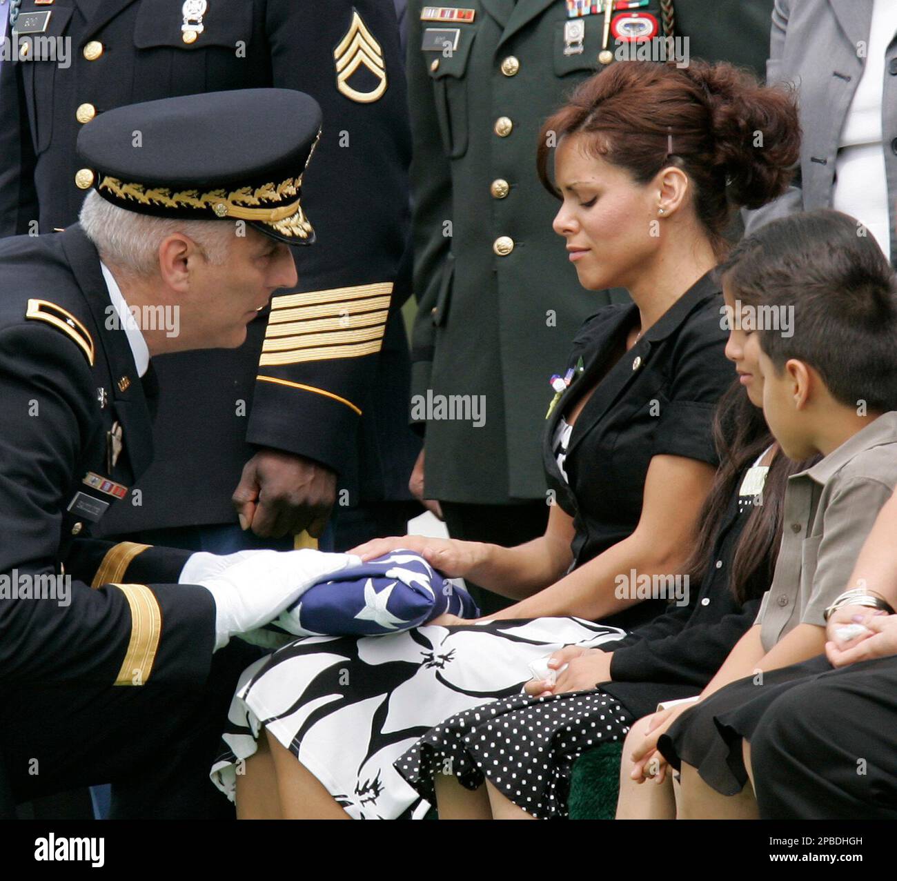 Brig. Gen. Bennett Sacolick presents an American flag to Erika Wyckoff ...