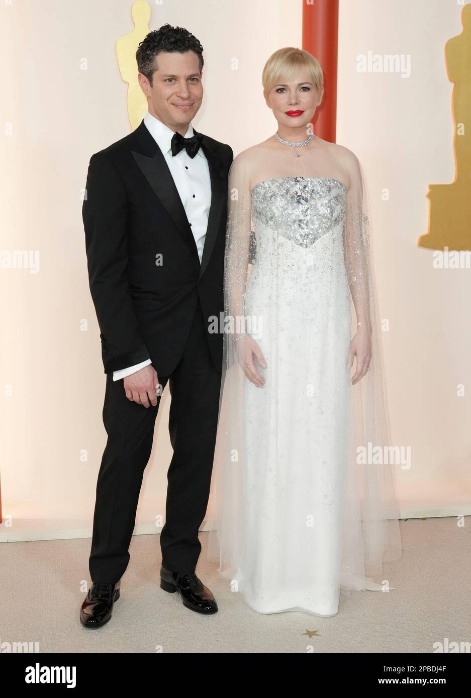 Thomas Kail, left, and Michelle Williams arrive at the Oscars on Sunday ...