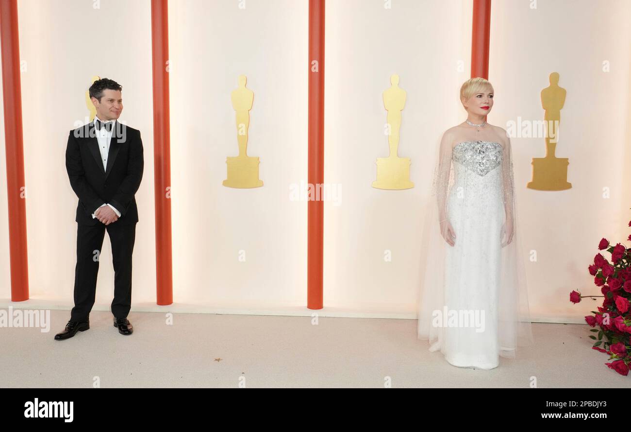 Thomas Kail, left, and Michelle Williams arrive at the Oscars on Sunday ...