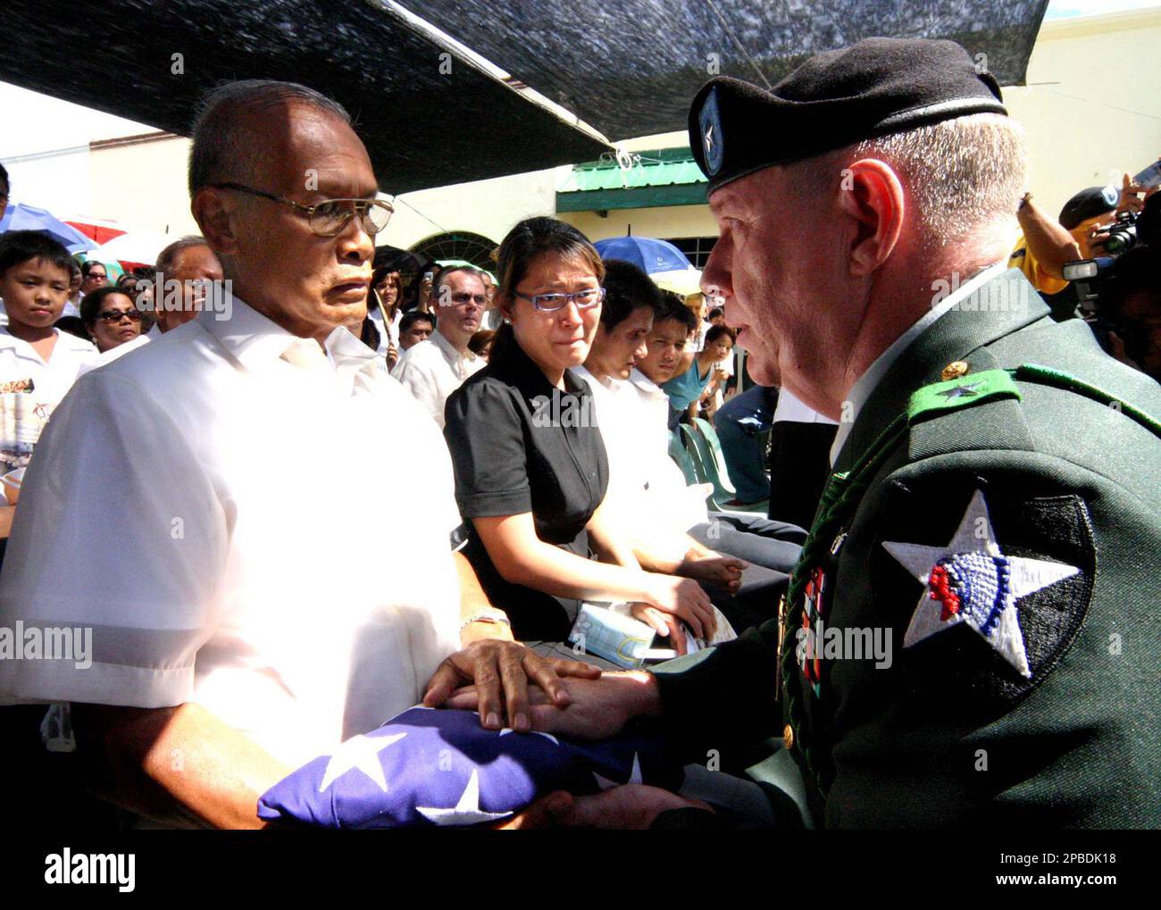 Richard Benito Primicias, left, received the U.S. flag from U.S ...