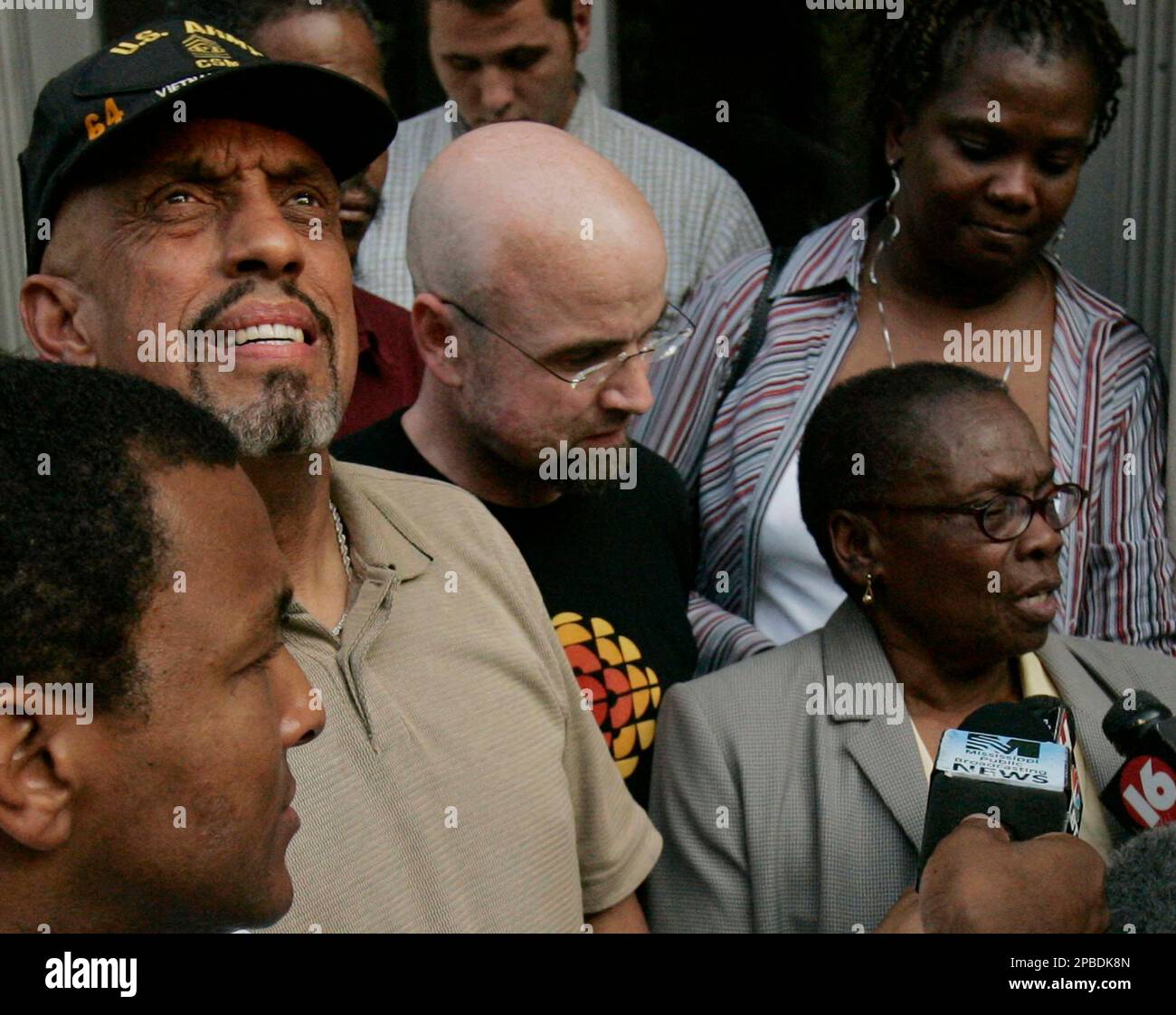 Thomas Moore, second from left, the older brother of victim Charles ...