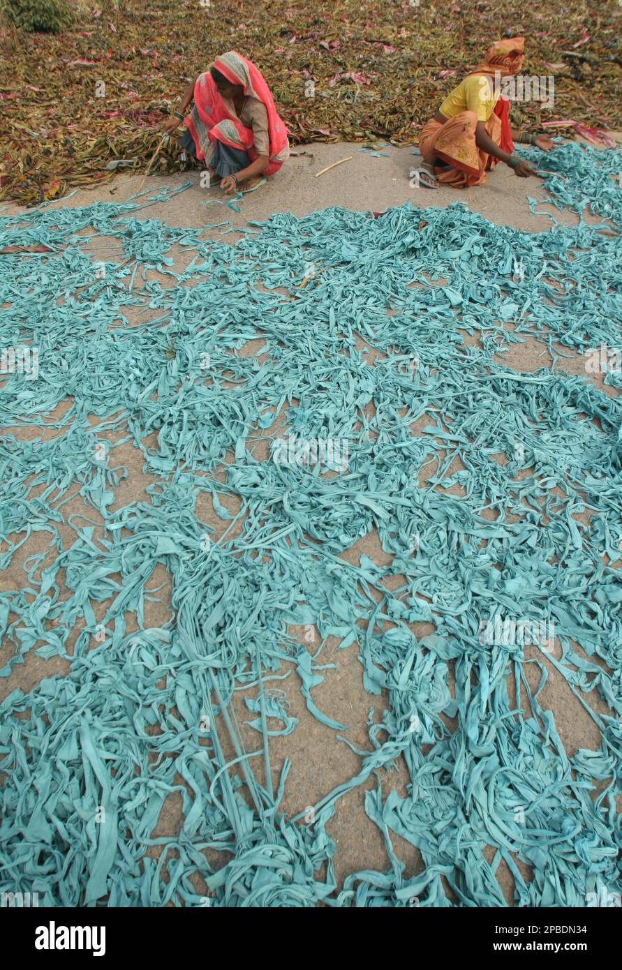 Indian woman workers dry shredded clothes, a byproduct of the textile ...