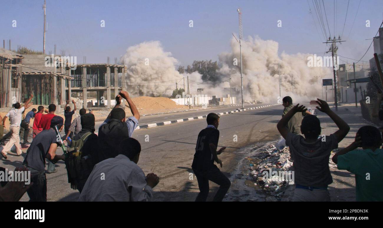Palestinians run in the direction of an explosion at the Preventive ...