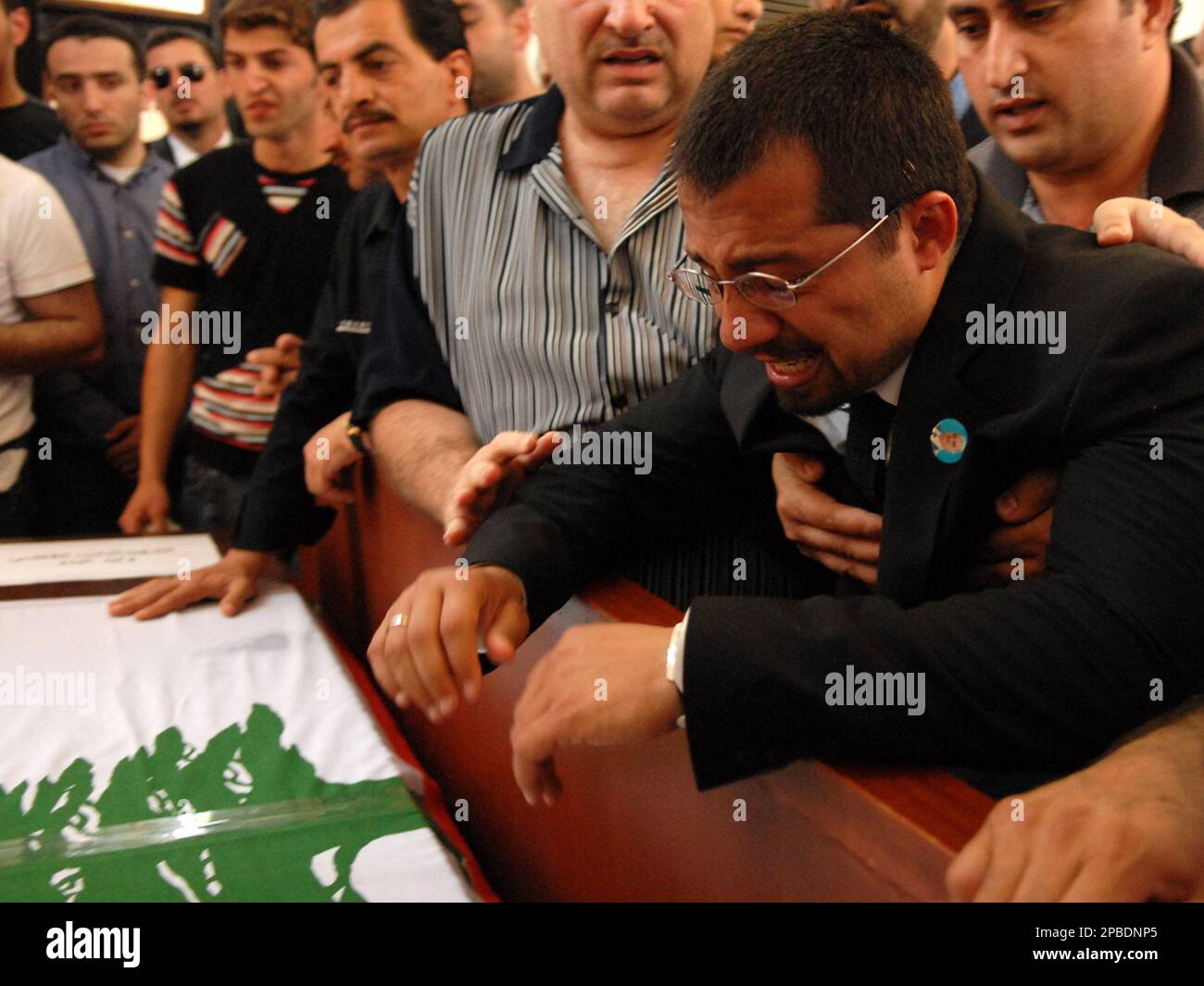 Mazen Eido, right, the son of assassinated lawmaker Walid Eido cries at ...