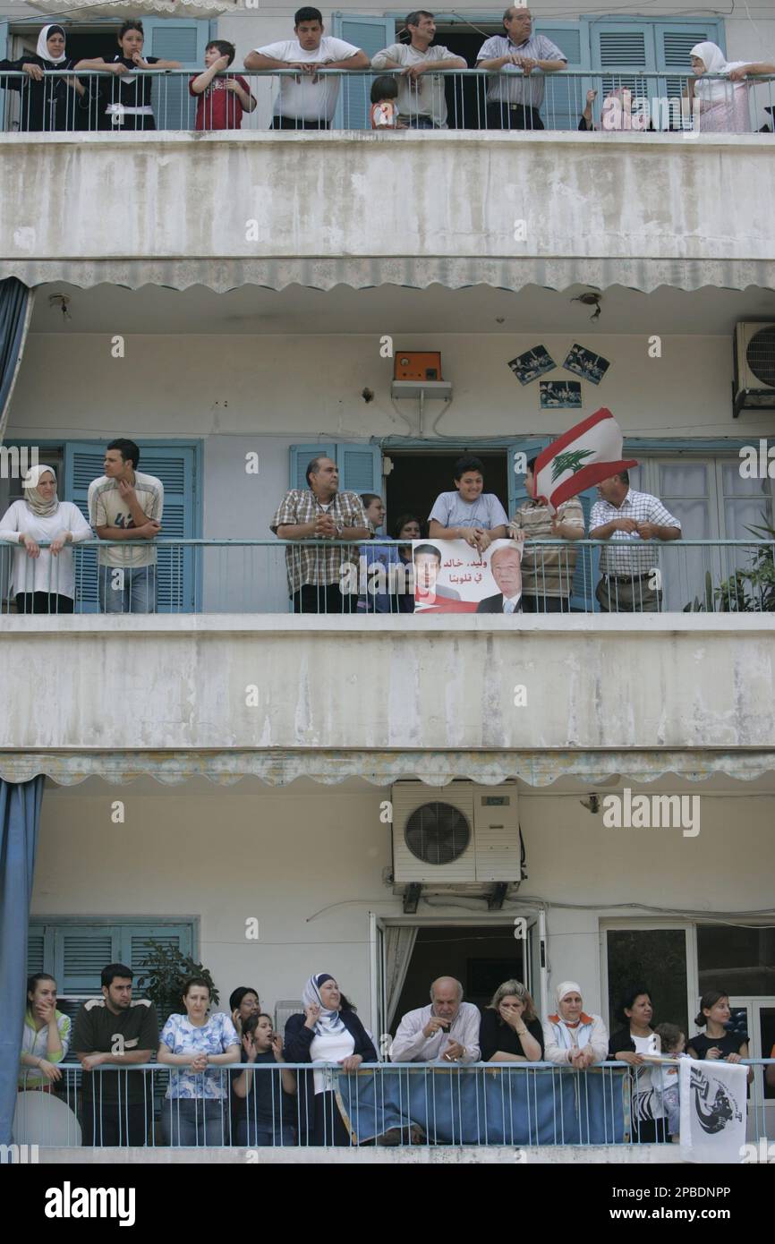 Lebanese people, look out from the balcony of their homes as they watch ...