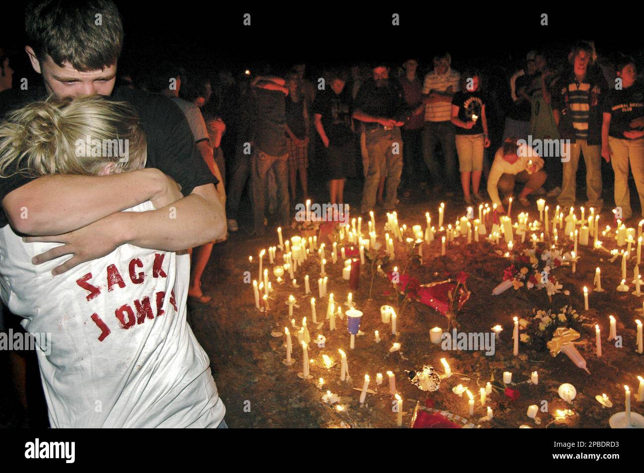 Justin Lowden, 17, and Brandy Franklin, 15, embrace during a candle ...