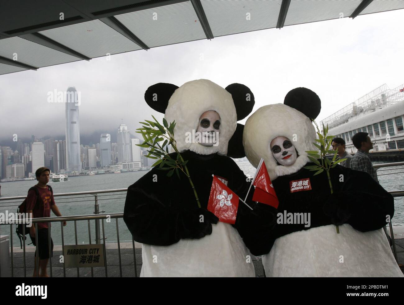 Actors dressed as giant pandas pose outside a Hong Kong shopping mall ...