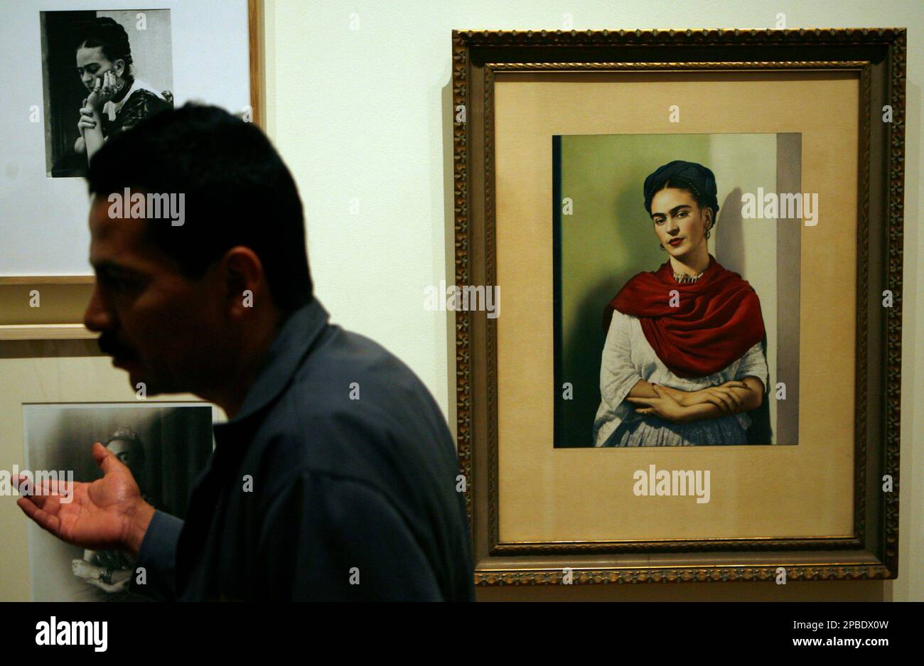 A museum technician gestures as he discusses the arrangement of ...