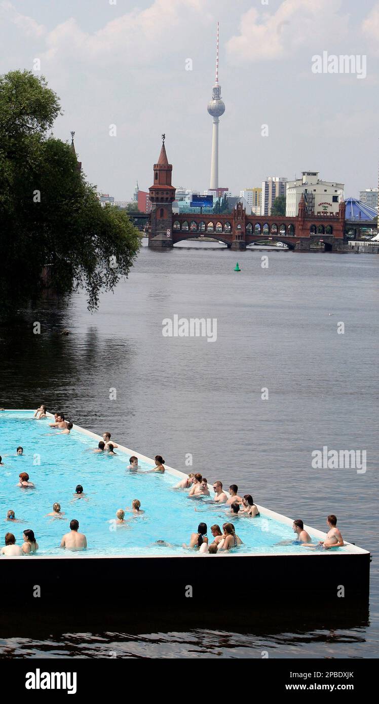 People relax in an outdoor swimming pool set into the River Spree in ...