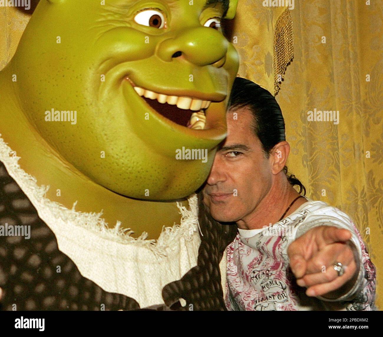 Spanish actor Antonio Banderas reacts as he poses with a model of the ...