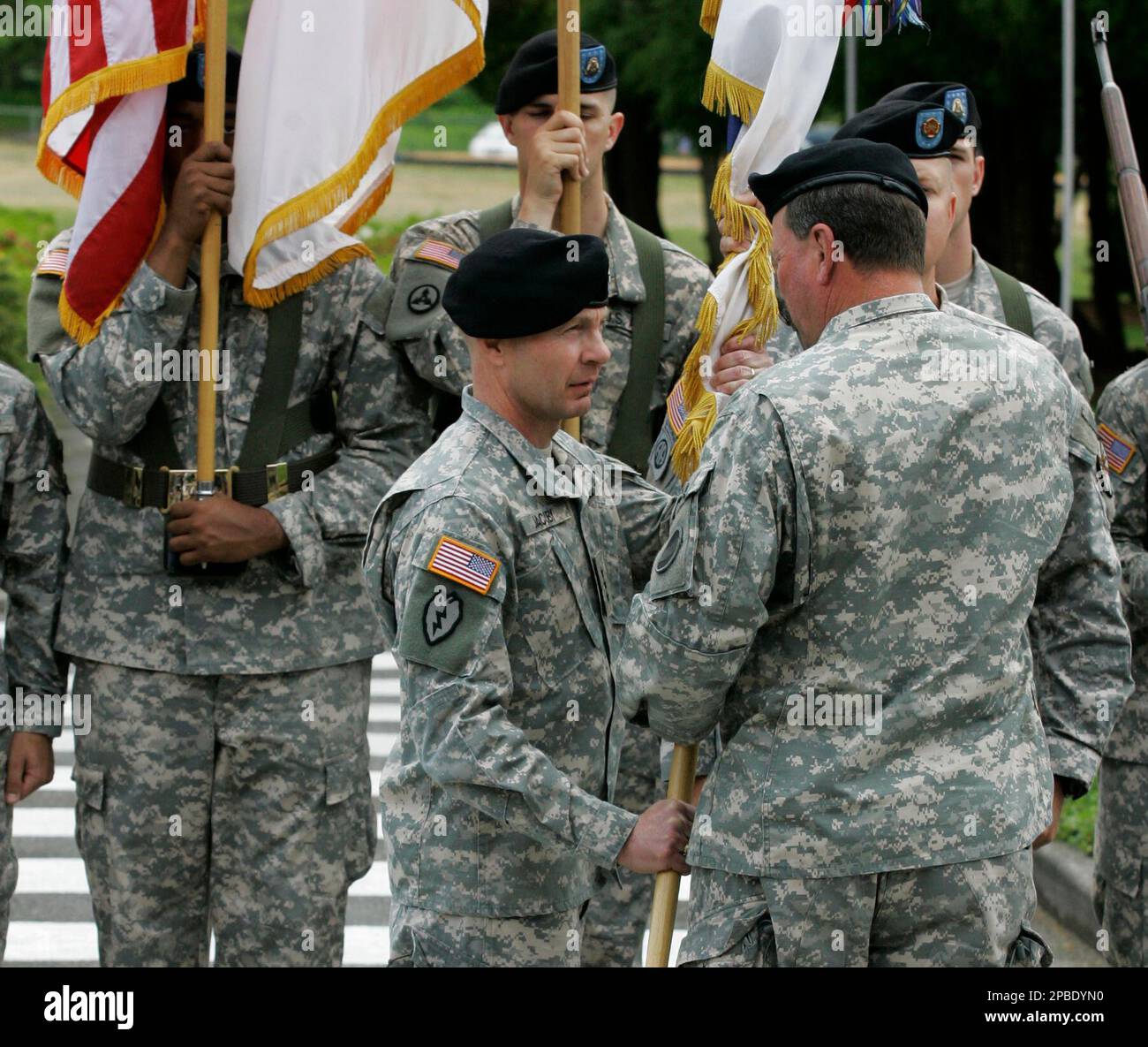 Lt. Gen. Charles Jacoby Jr., left, receives flags that symbolize his ...