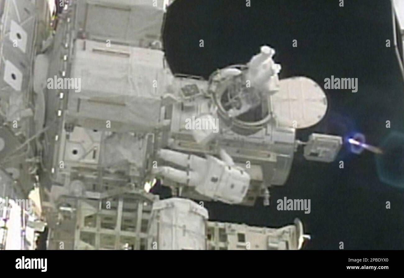 In this image made from NASA TV, Astronaut Danny Olivas, top exits the ...