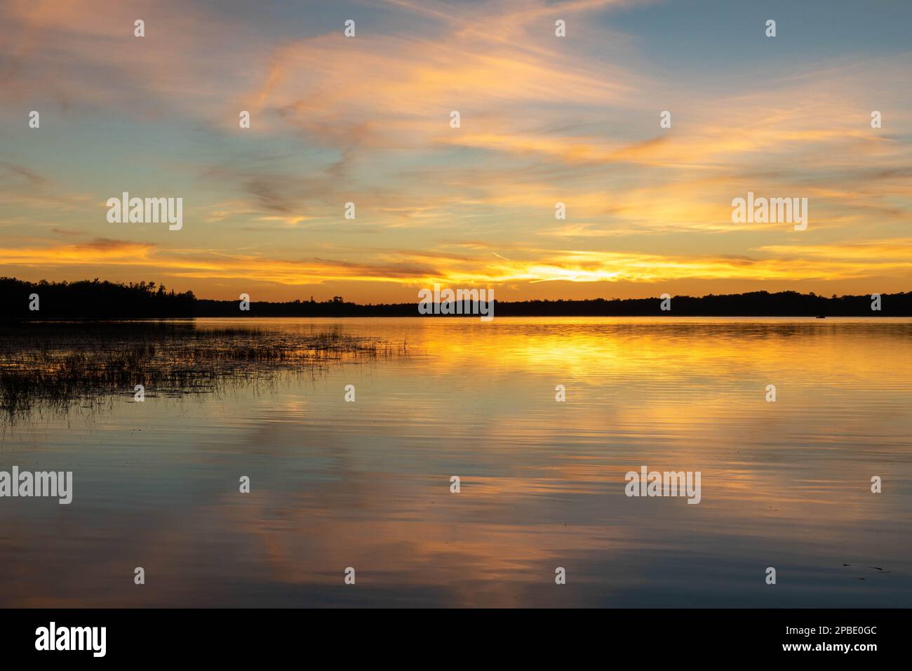 Beautiful sunsets in northern fishing lake illustrate tremendous color ...